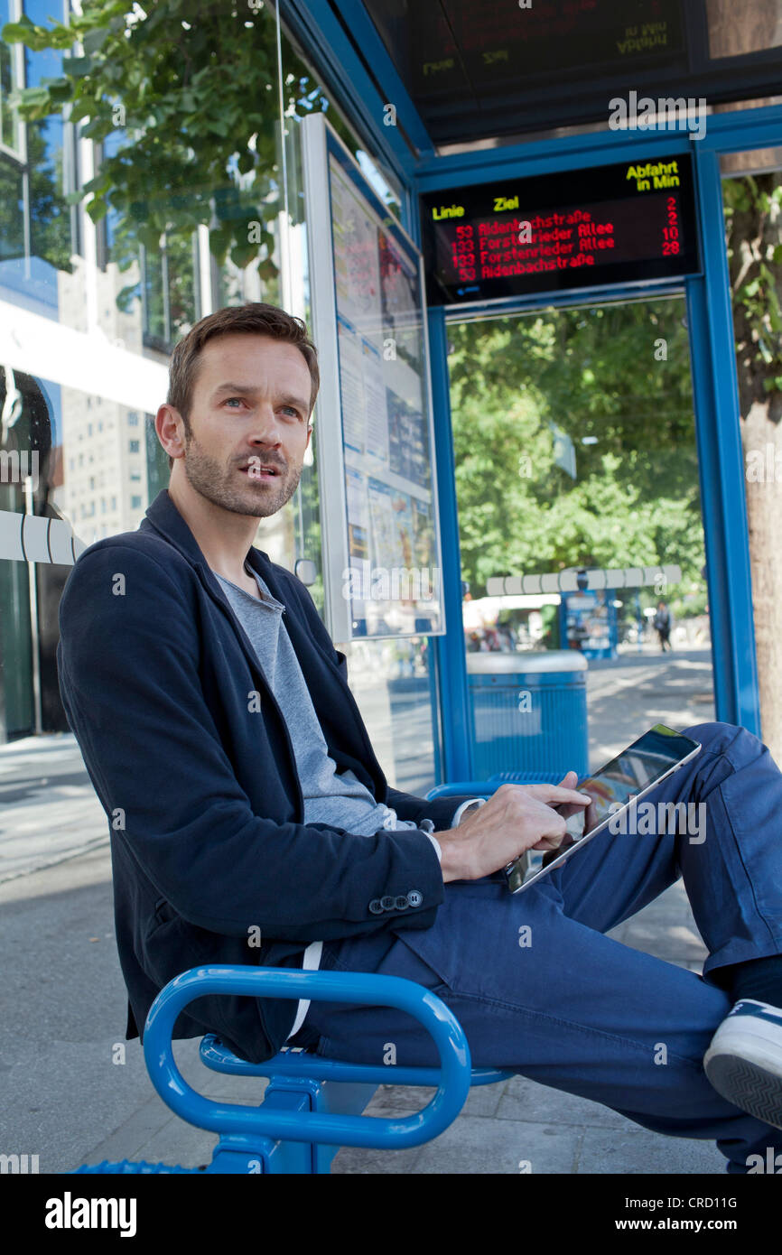 Man with ipad outdoors Stock Photo - Alamy