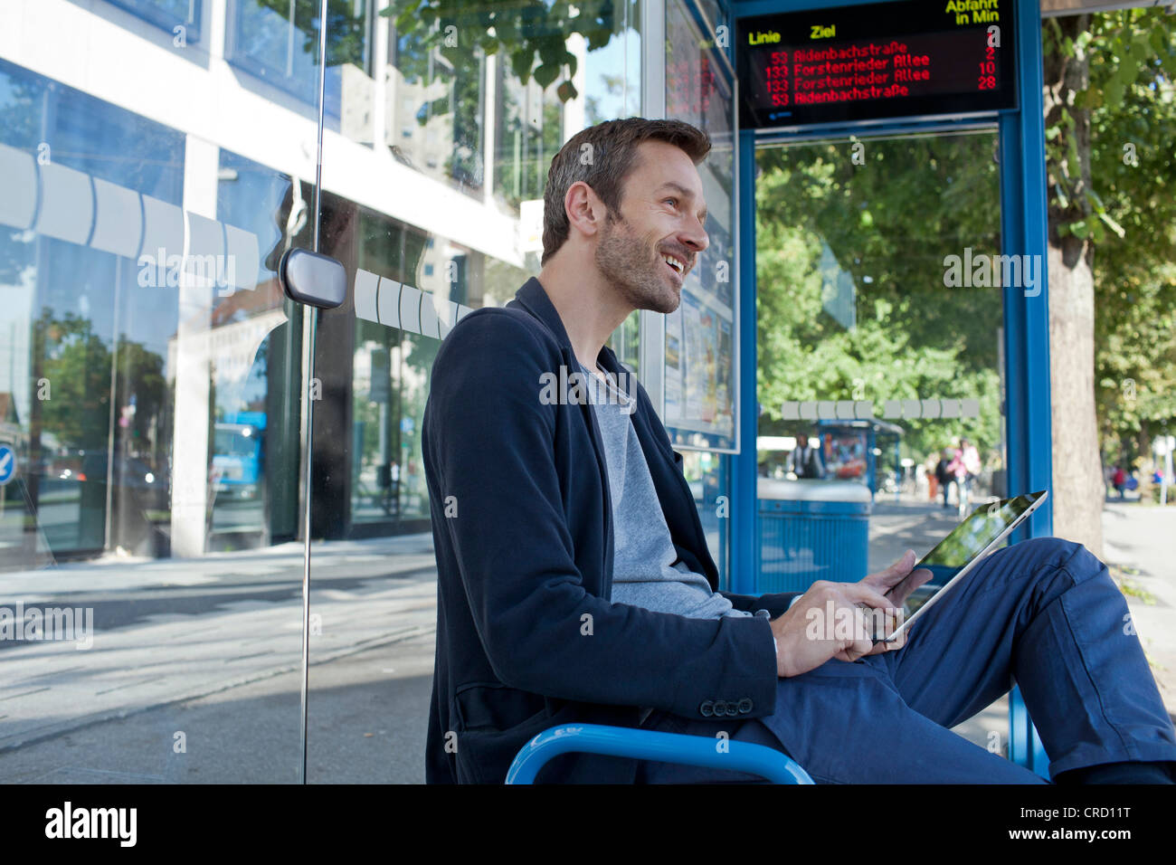 Man with ipad outdoors Stock Photo - Alamy