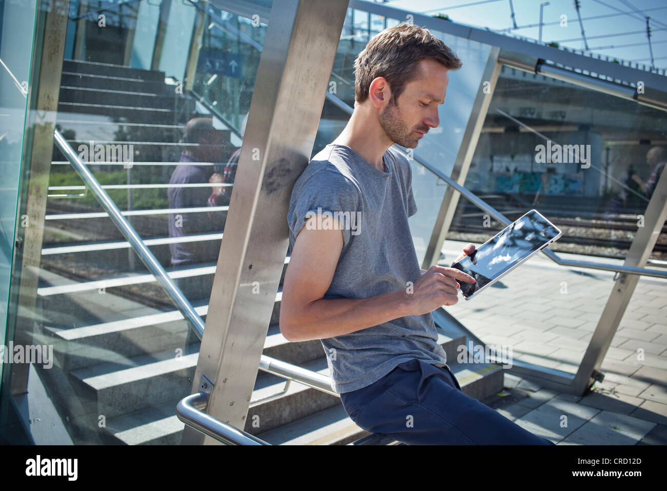 Man with ipad outdoors Stock Photo - Alamy