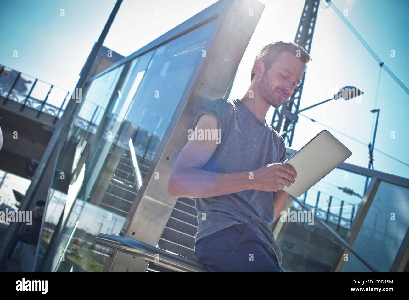 Man with ipad outdoors Stock Photo - Alamy