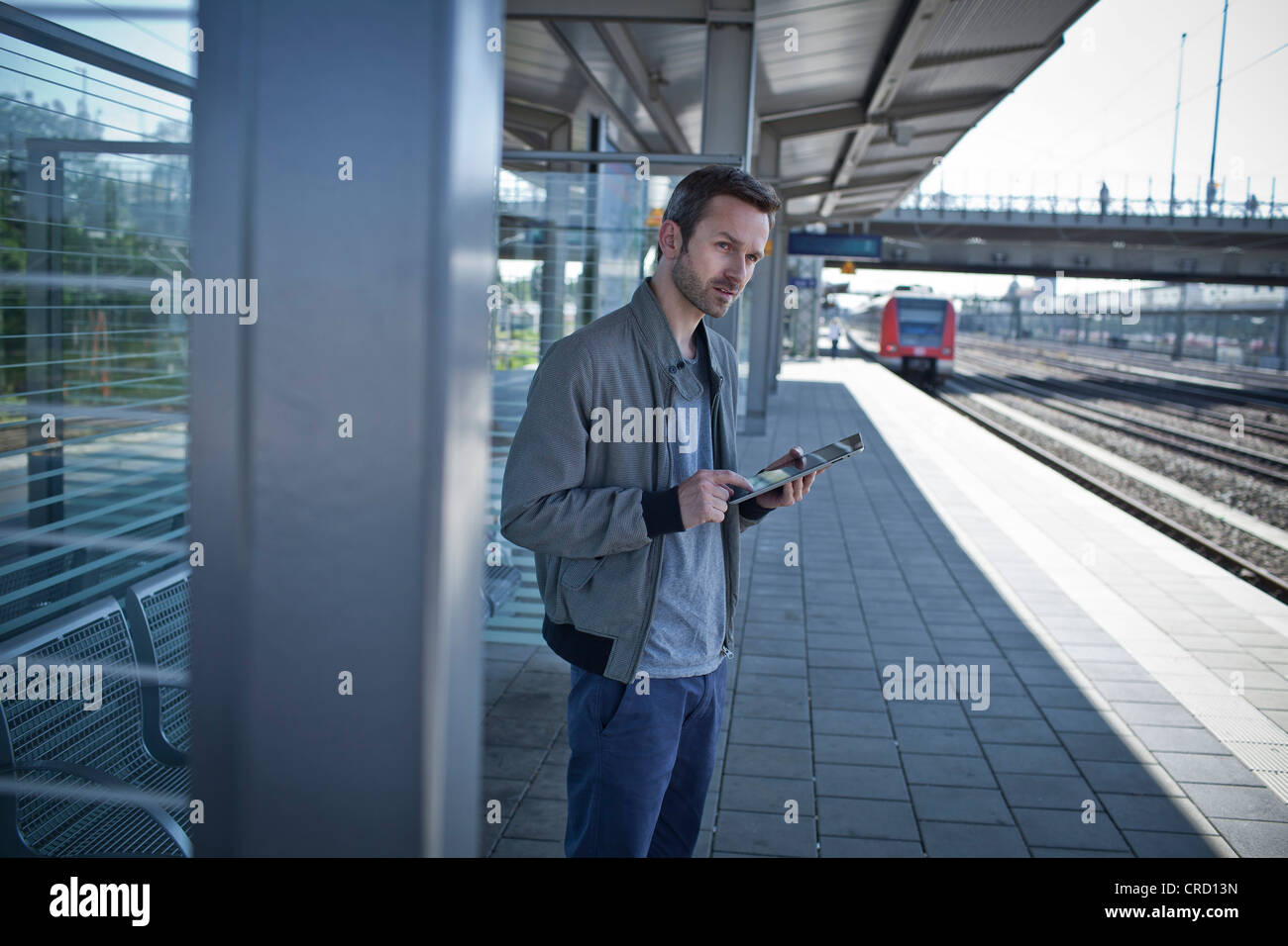 Man with ipad outdoors Stock Photo - Alamy