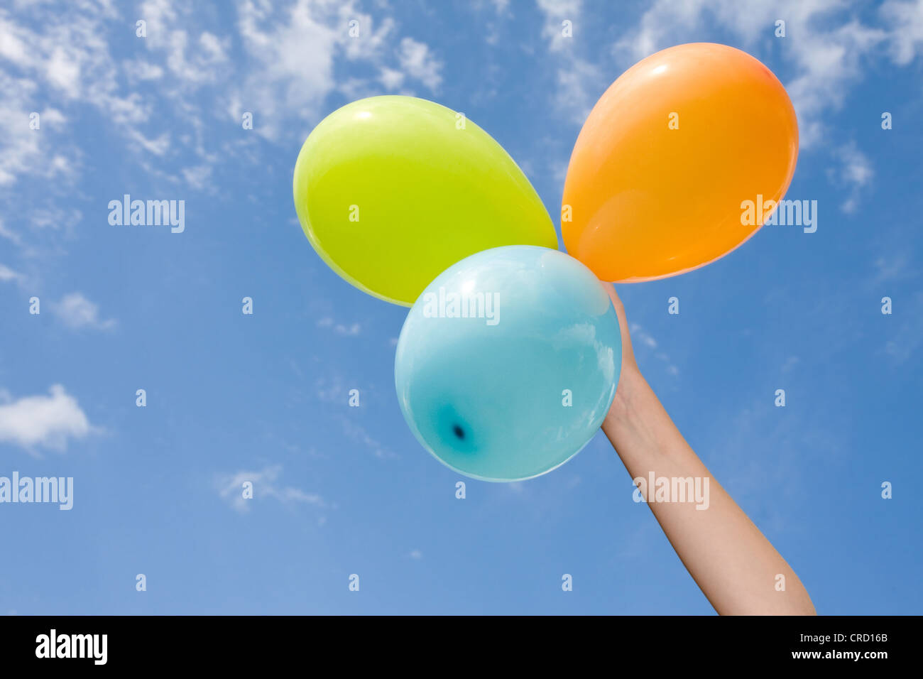 hand with color balloons on sky background Stock Photo - Alamy