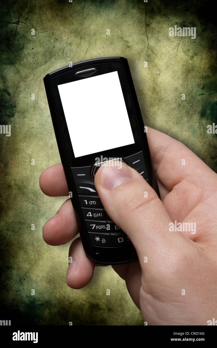 hand with black mobile phone on dark background Stock Photo - Alamy