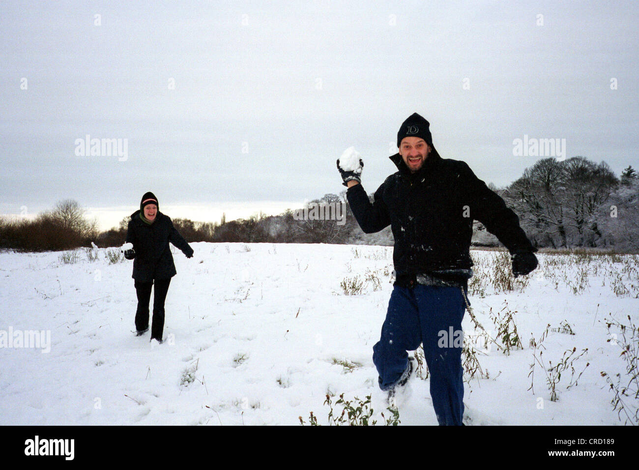 Snowball fight in a winter landscape Stock Photo - Alamy