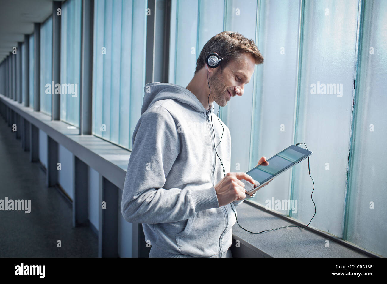Man with ipad outdoors Stock Photo - Alamy