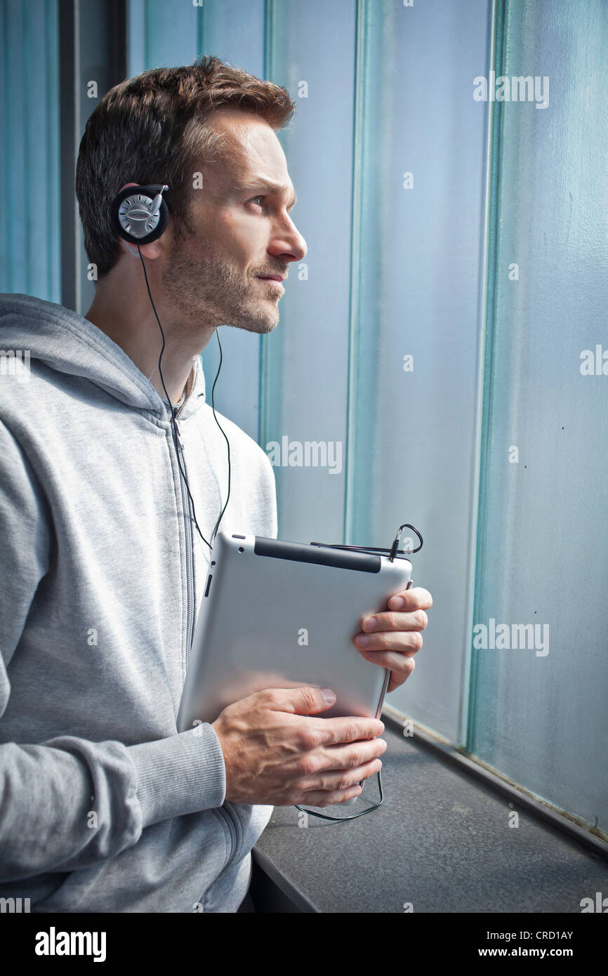 Man with ipad outdoors Stock Photo - Alamy