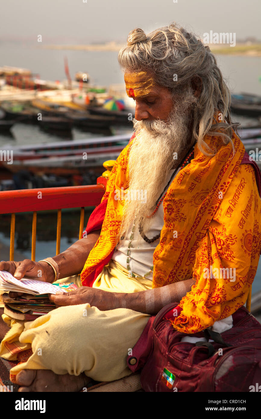 Sadhu (holy man) reading holy book in Varanasi, Uttar Pradesh, India ...