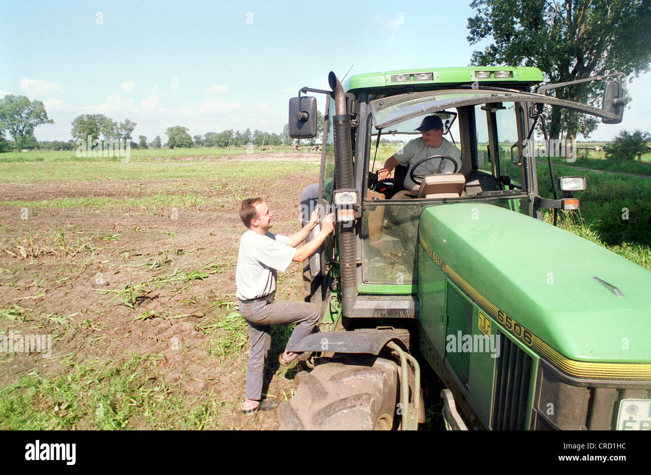 Two young farmers in Conversation on the field Stock Photo - Alamy