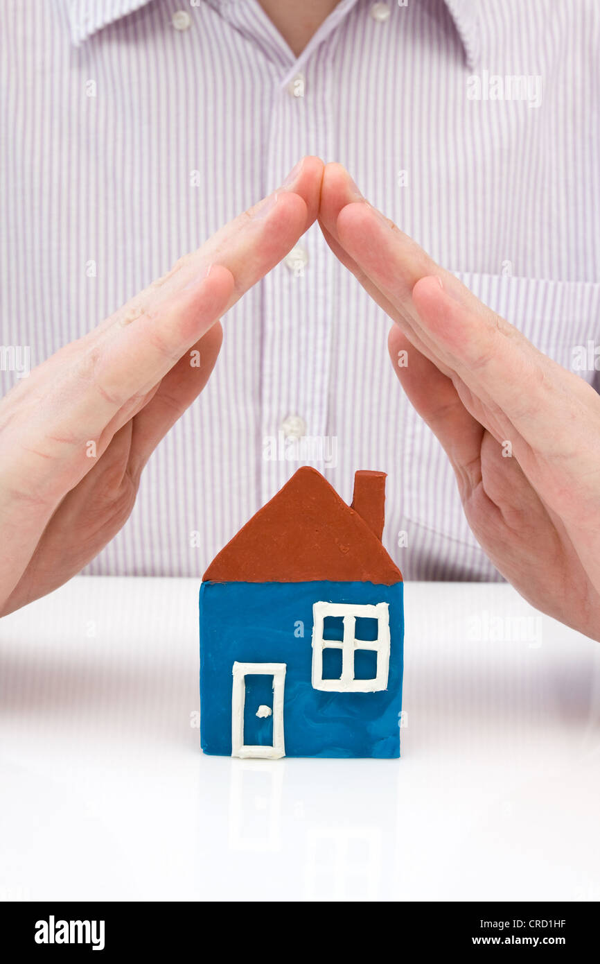 human hands covering house made from plasticine Stock Photo - Alamy