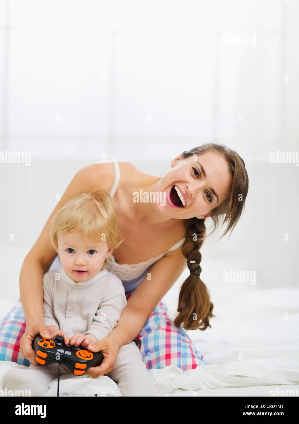 Mother playing with baby on console Stock Photo - Alamy