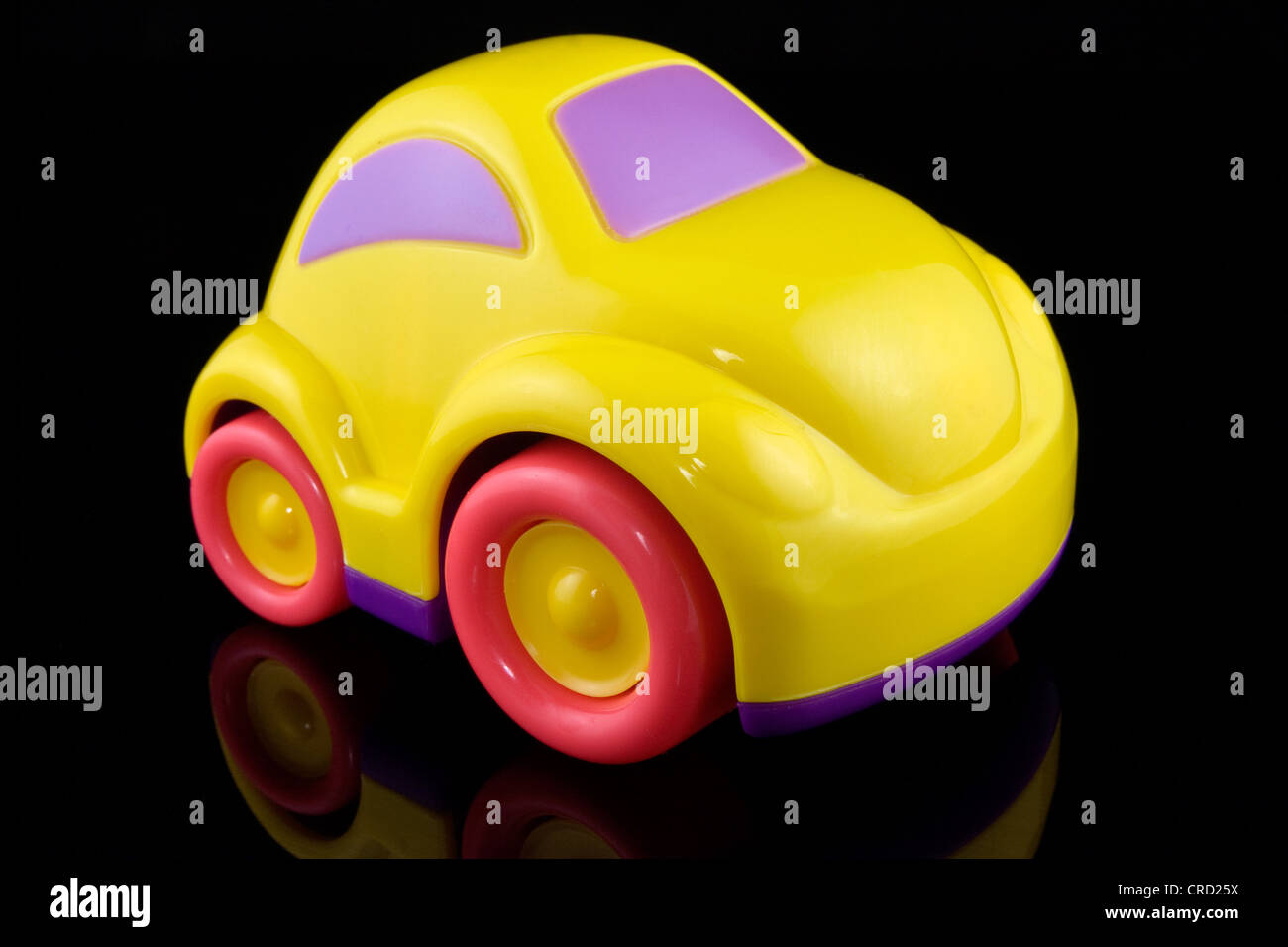 yellow plastic car with reflection on black background Stock Photo - Alamy