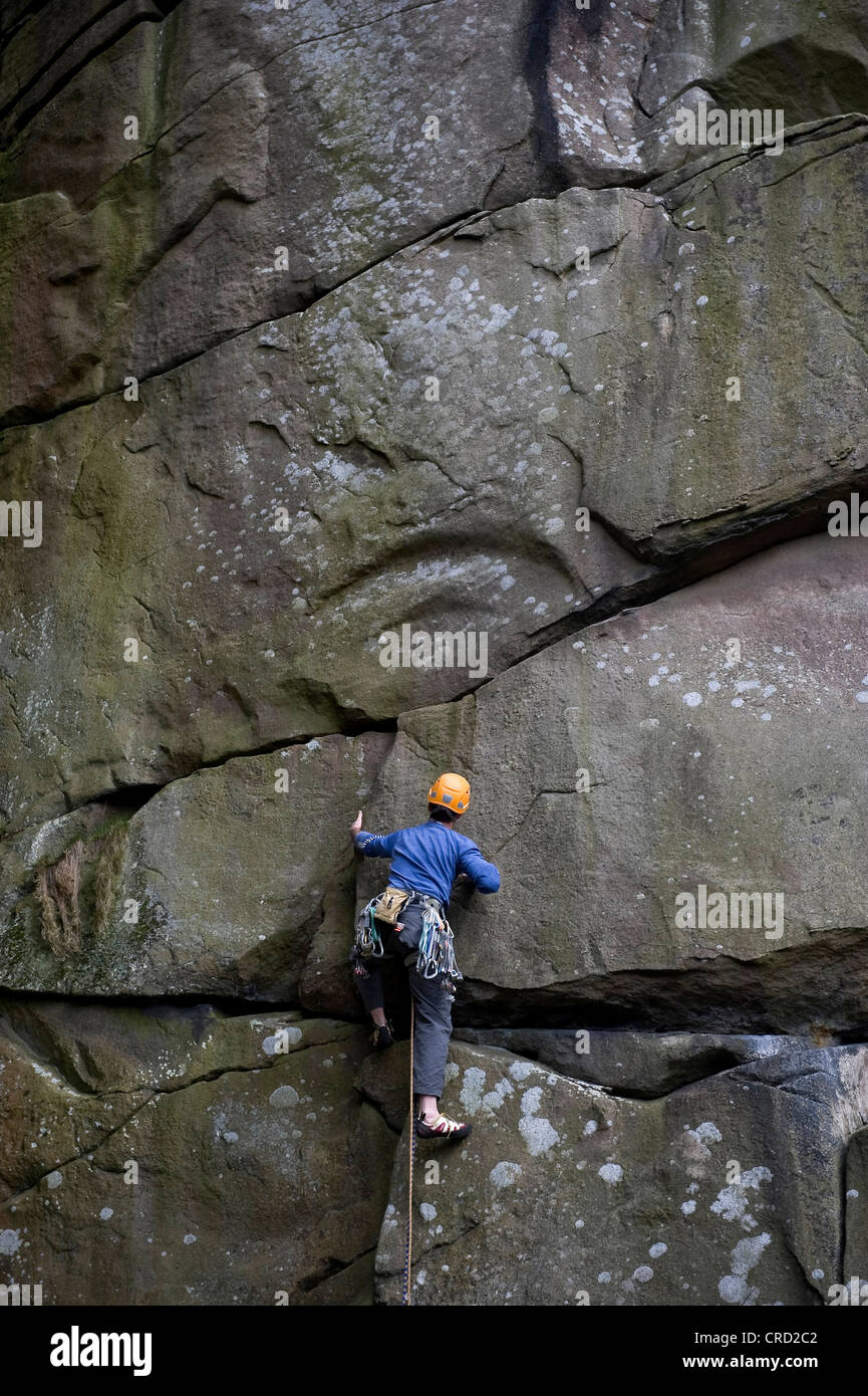 Rock climber on The Crack at Cratcliffe Rocks in the Peak District ...