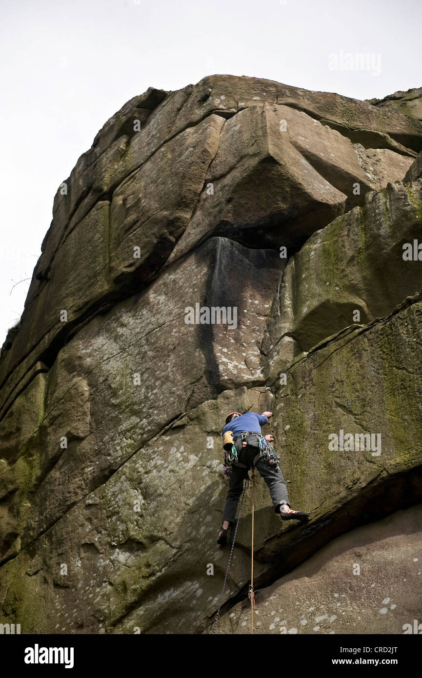 Rock climber on The Crack at Cratcliffe Rocks in the Peak District ...
