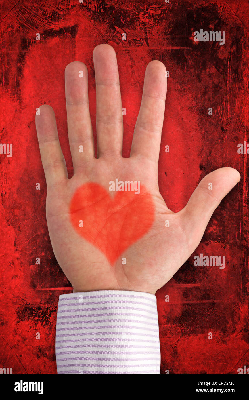 love concept. hand with heart shape on dark red background Stock Photo ...
