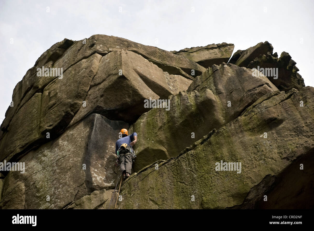 Rock climber on The Crack at Cratcliffe Rocks in the Peak District ...
