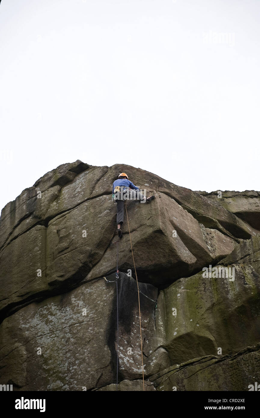 Rock climber on The Crack at Cratcliffe Rocks in the Peak District ...