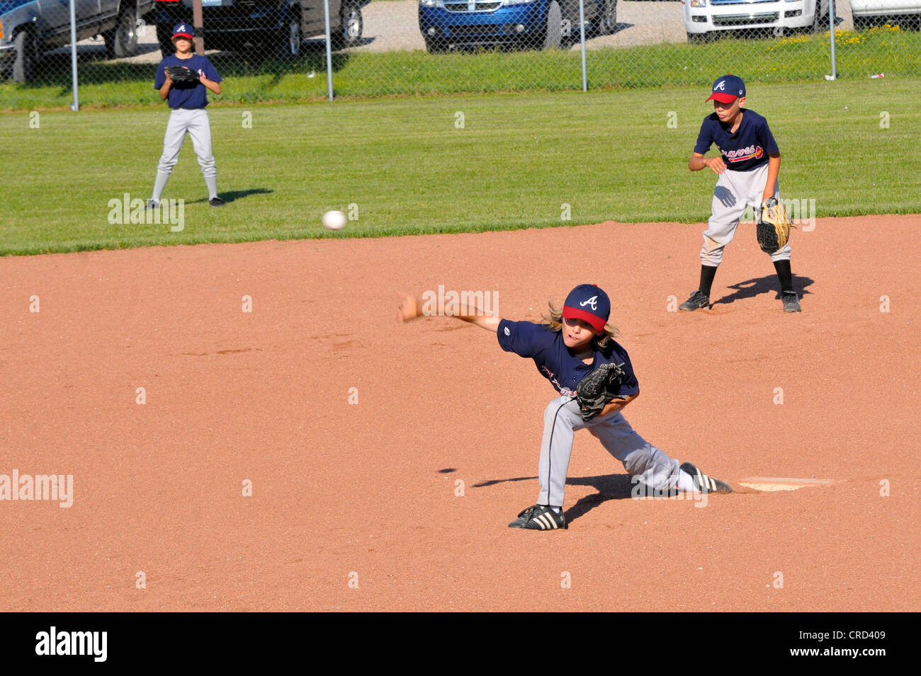 Little League baseball pitcher throwing baseball Stock Photo - Alamy