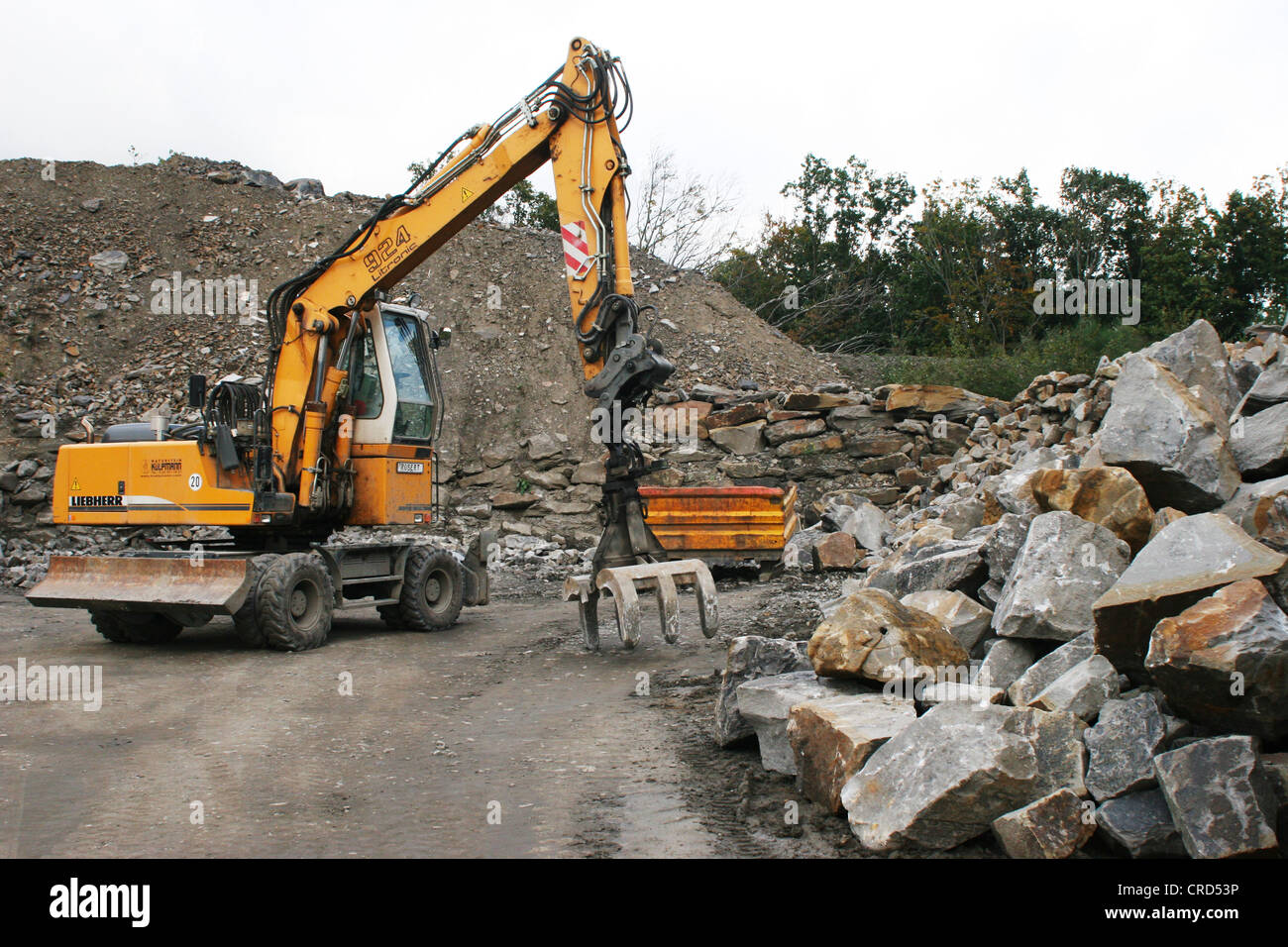 sandstone and excavator in stone quarry, Germany, North Rhine ...