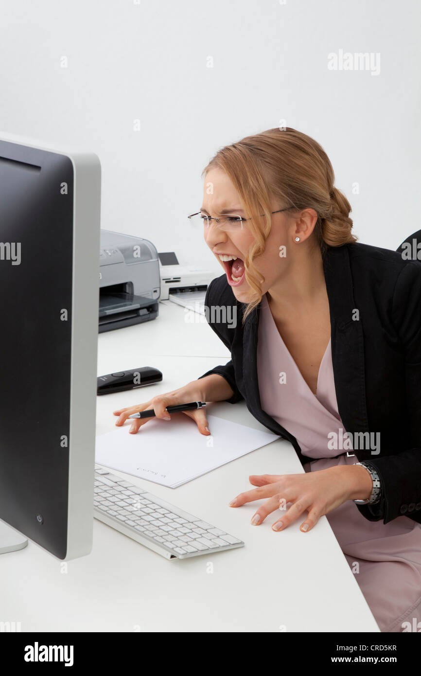 Desperate young woman in office Stock Photo - Alamy