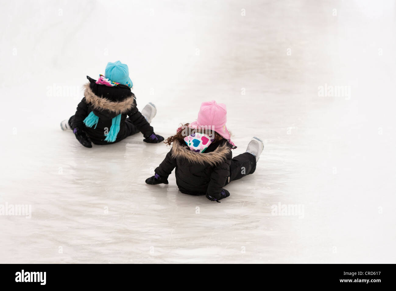 Two girls slide down an ice slide. At the Snowflake Kingdom at ...