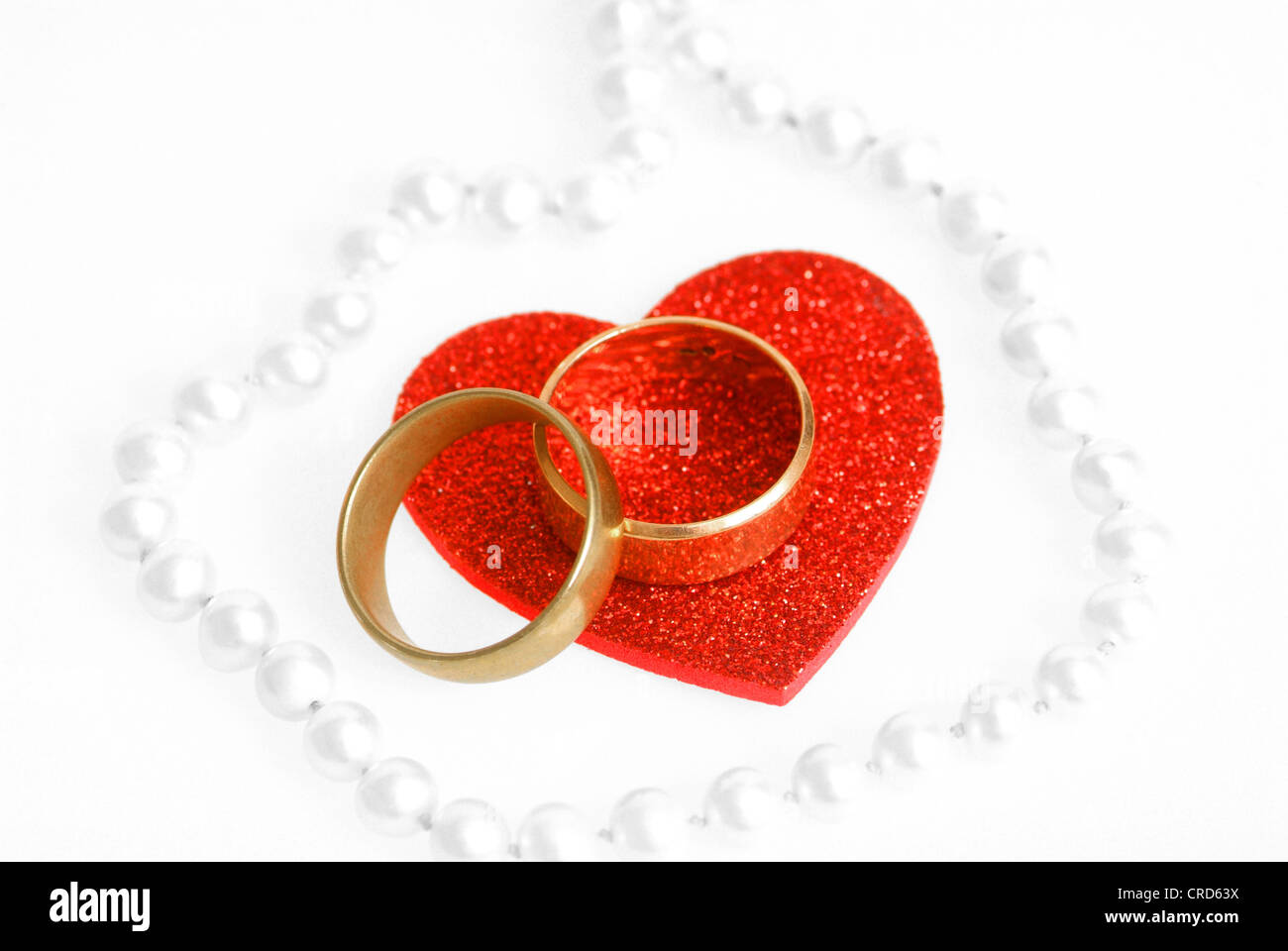 wedding rings with heart Stock Photo - Alamy