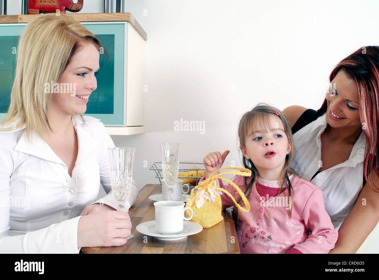 two friends with child get-together Stock Photo - Alamy