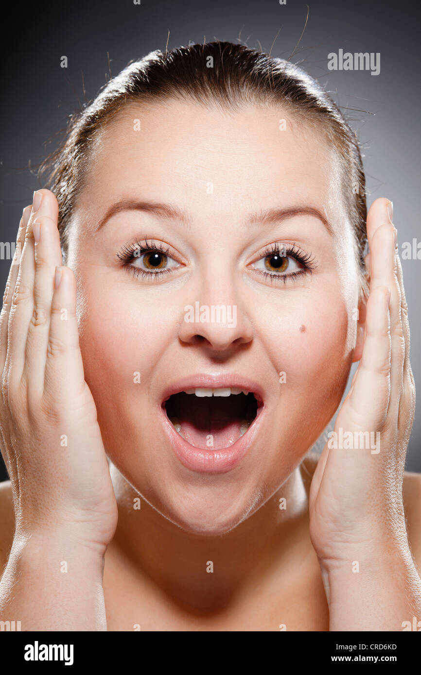 Young woman with surprised look Stock Photo - Alamy