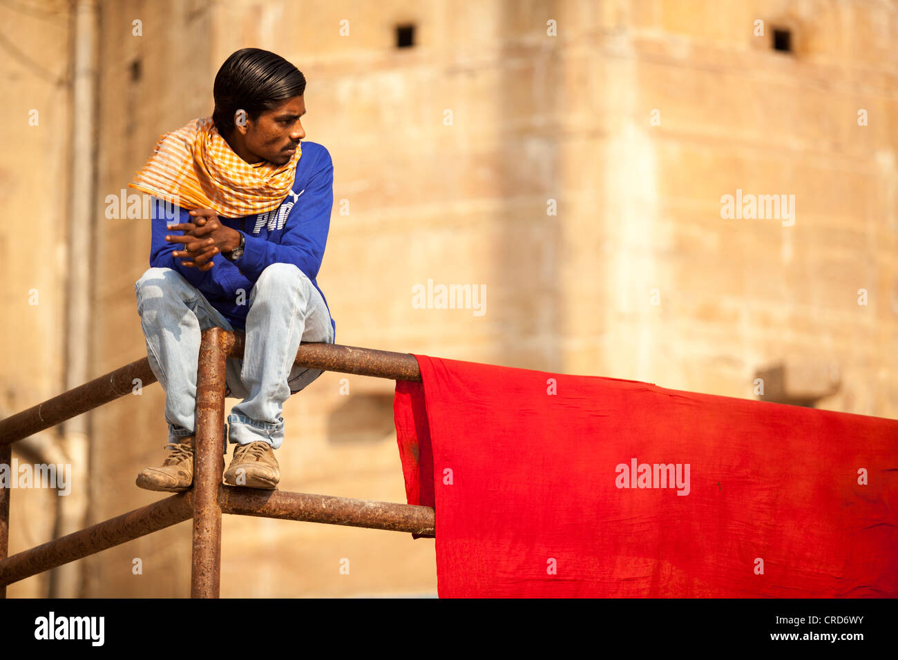 Hindu pilgrim sitting on balustrade in Ghat, Varanasi, Uttar Pradesh ...