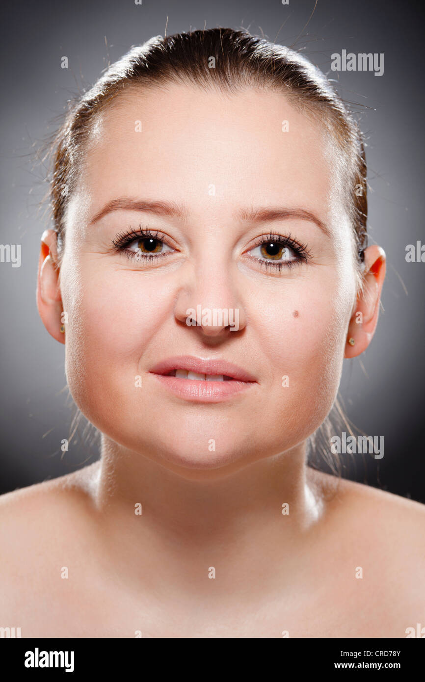 Young woman with a slightly disgusted look Stock Photo - Alamy