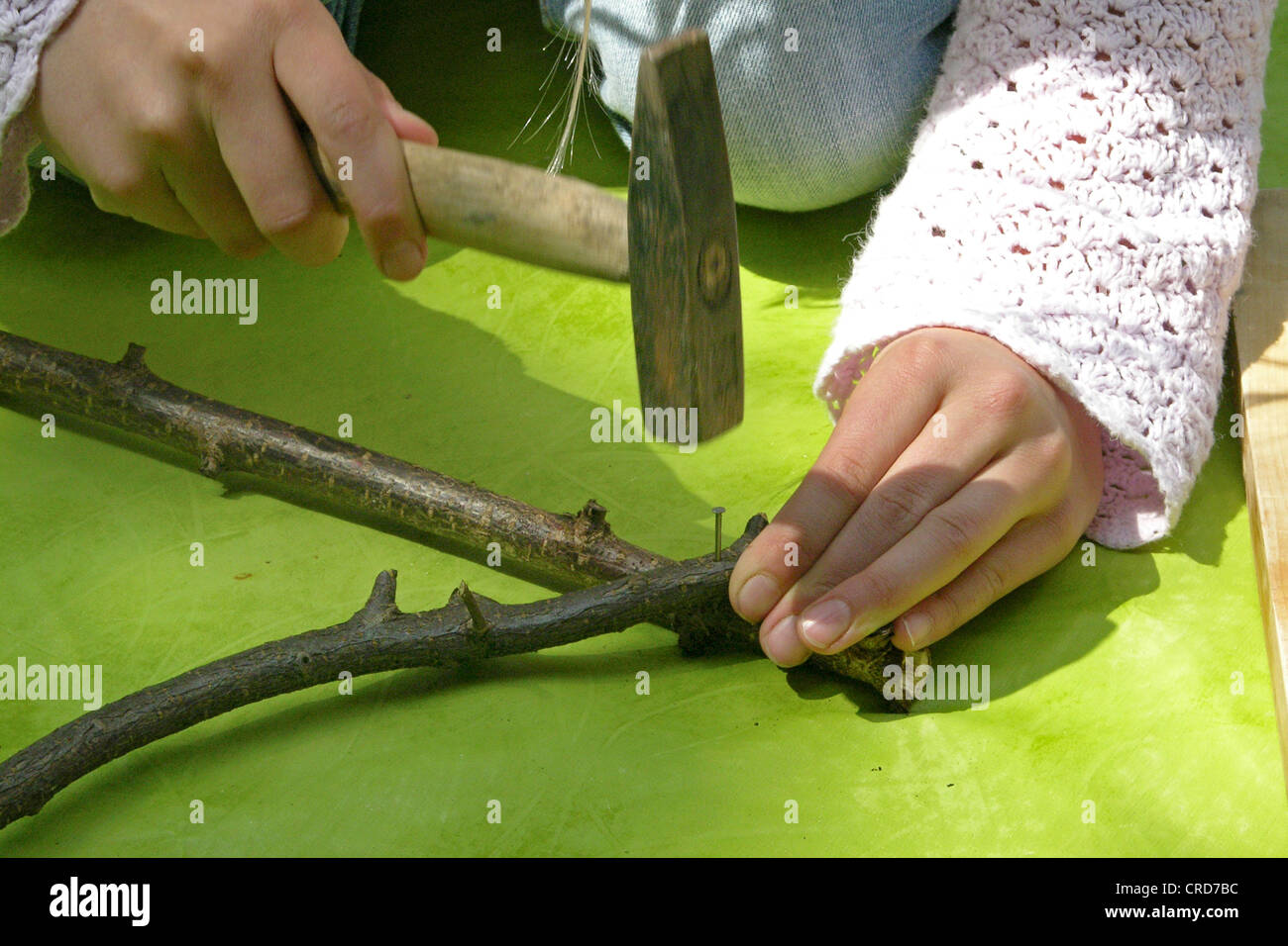 little girl building a picture frame with twigs, series picture 2/7 ...