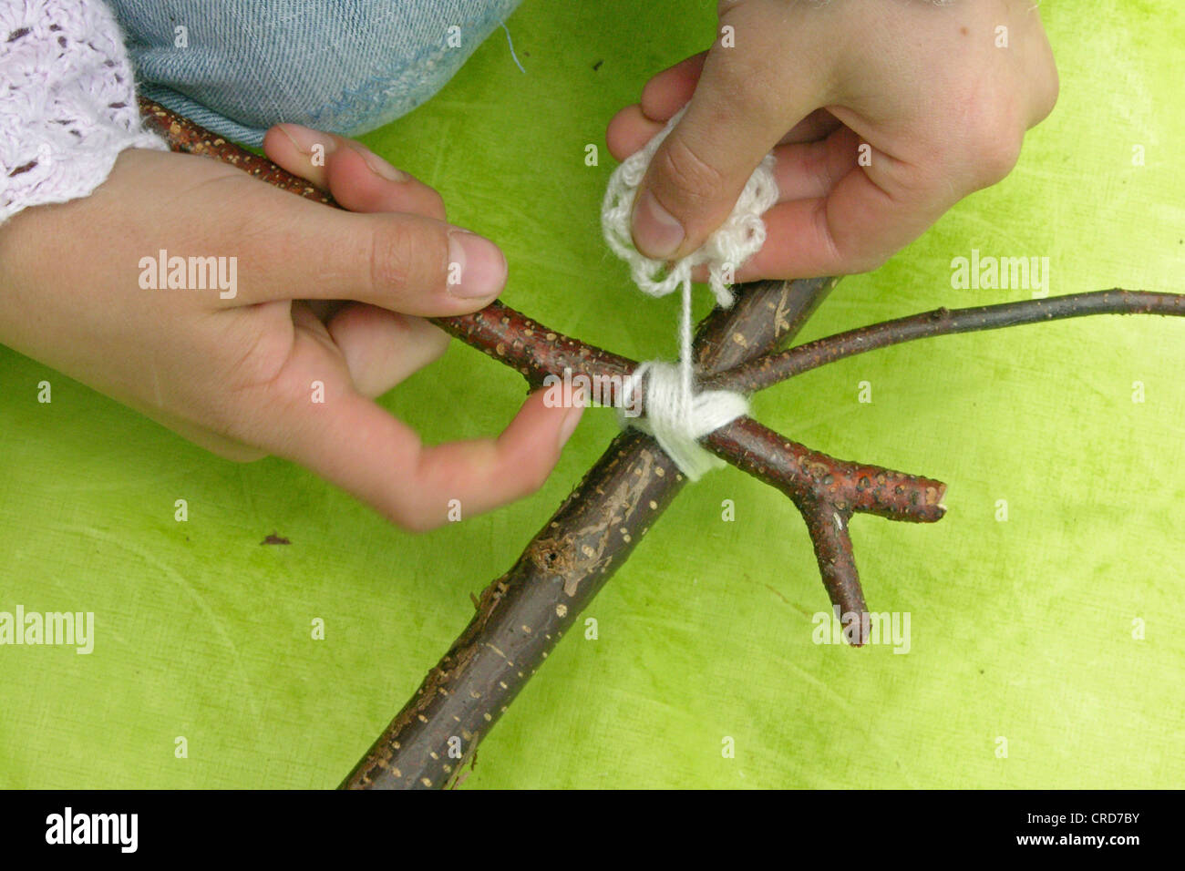 little girl building a picture frame with twigs, series picture 4/7 ...
