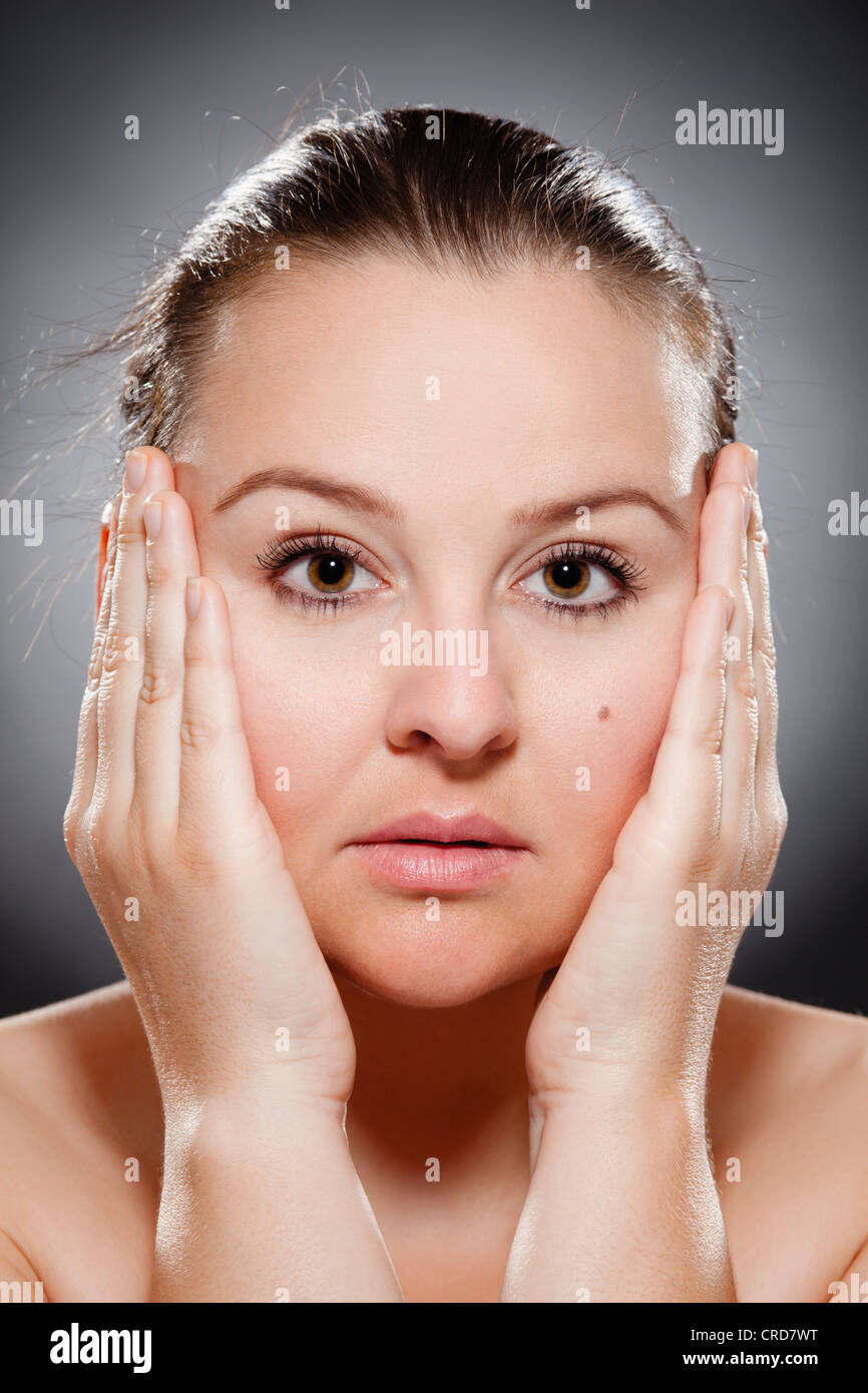 Young woman looking shocked Stock Photo - Alamy