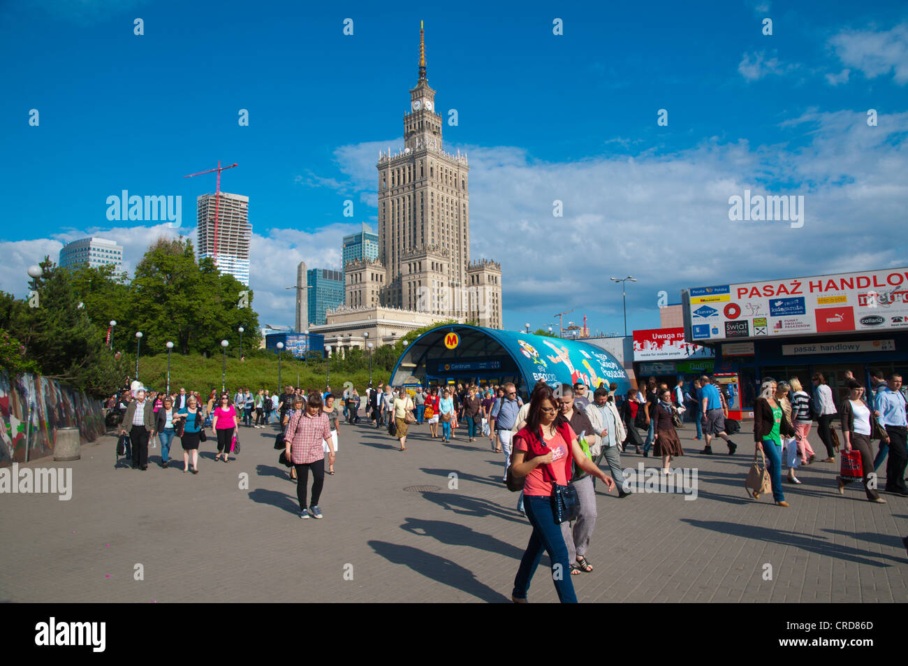 People exiting metro station with Palace of Culture and Science in ...
