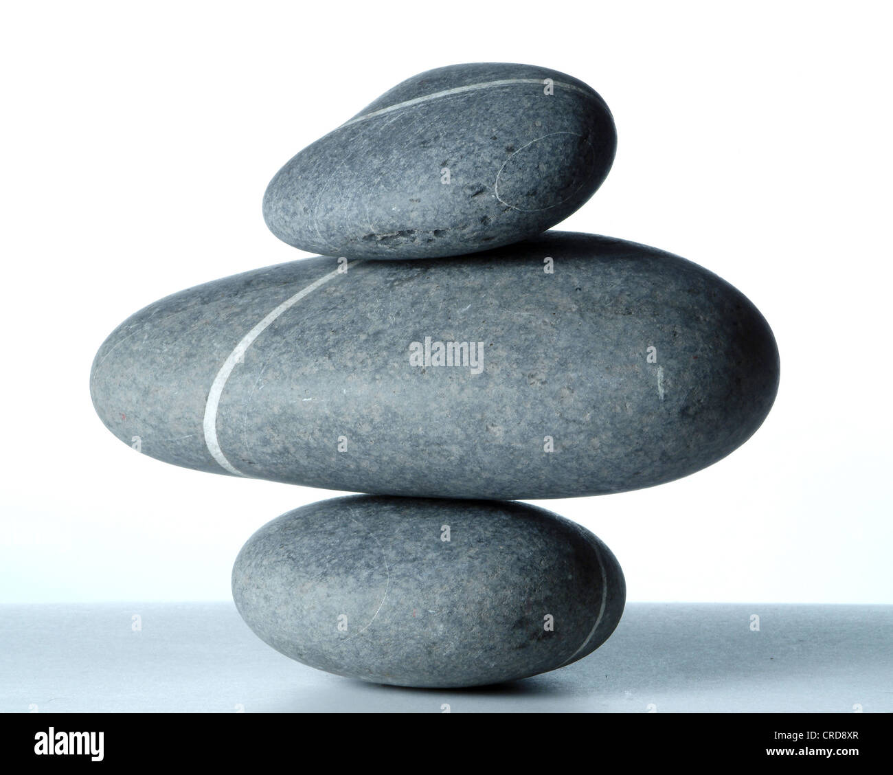 three stones in balance Stock Photo - Alamy