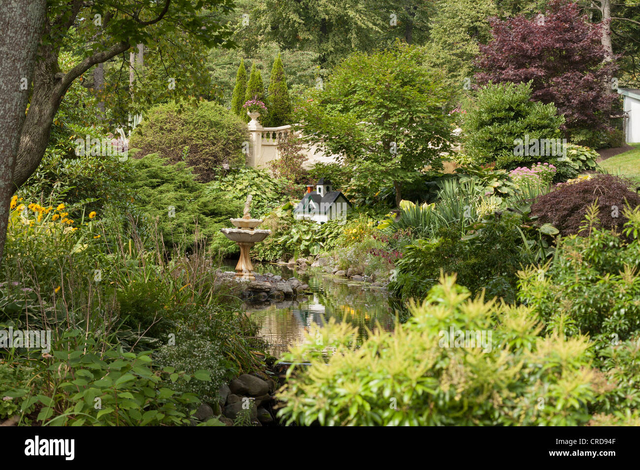 Lush Spring vegetation at the Halifax Public Gardens. A fountain and a ...