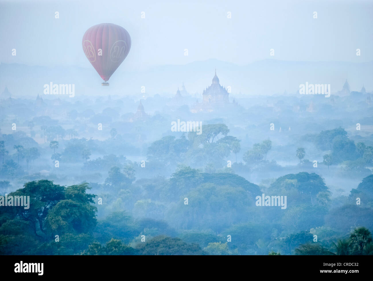 Hot air balloon at dawn over the landscape of pagodas in Bagan, Myanmar ...