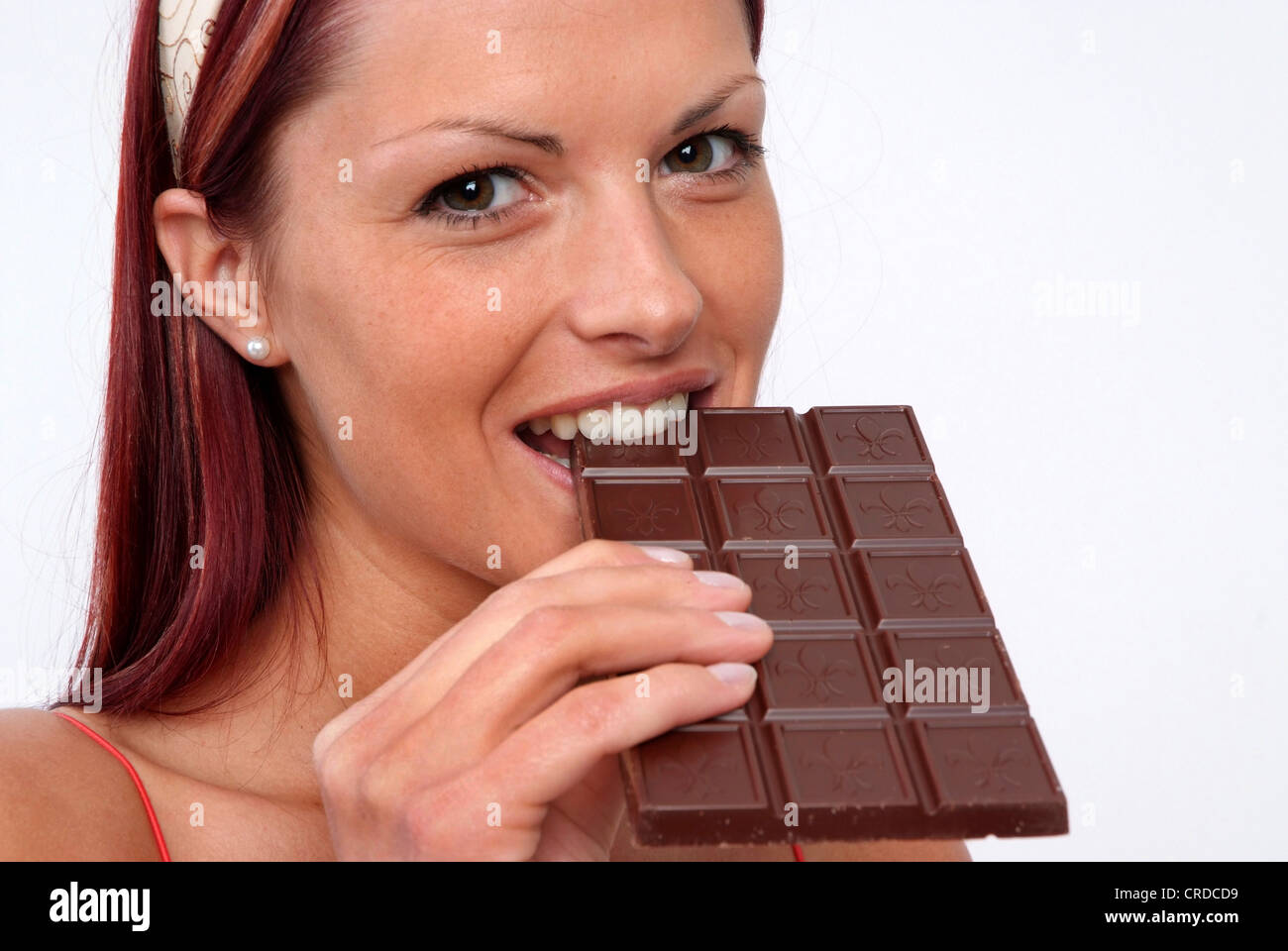 Woman eating chocolate red hair hi-res stock photography and images - Alamy