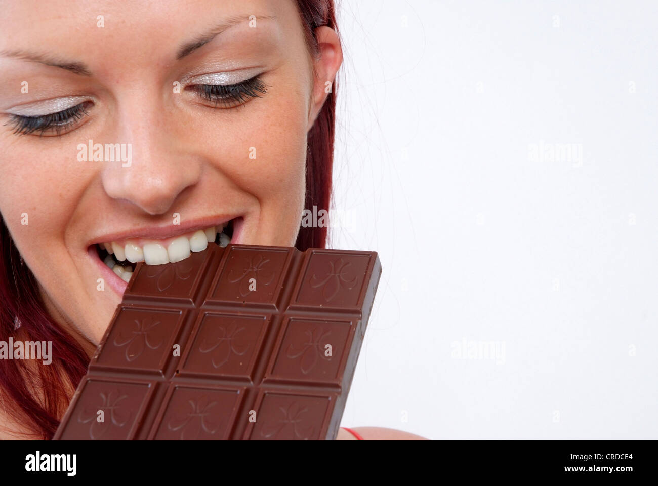 young woman eating a chocolate bar Stock Photo - Alamy