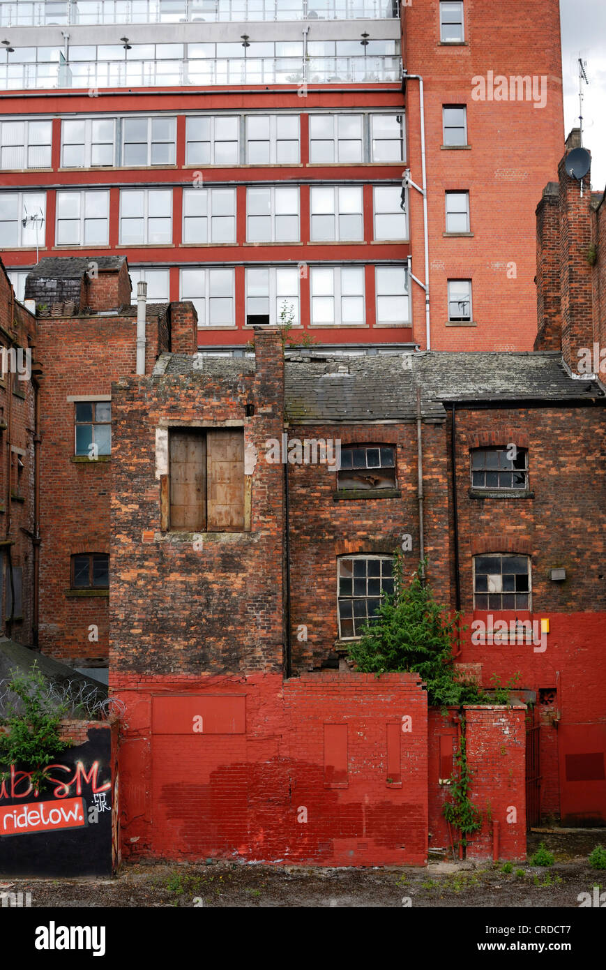 Derelict and decaying buildings in Manchester in front of modern ...