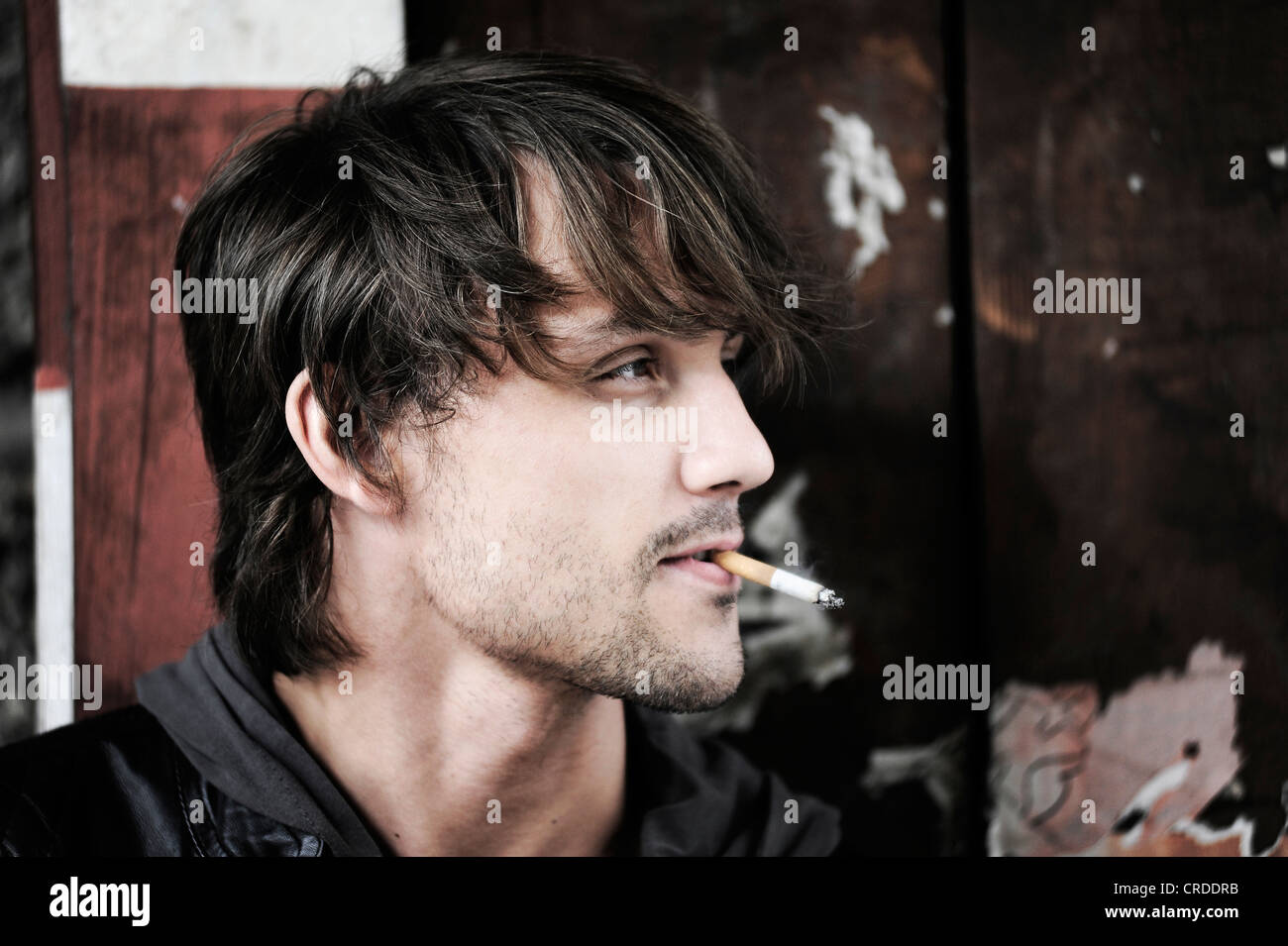 Young man smoking, portrait Stock Photo - Alamy