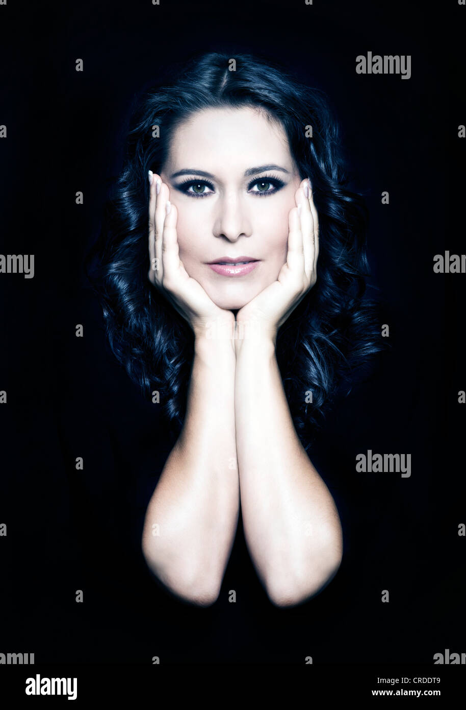 Woman supporting her head on her arms, portrait Stock Photo - Alamy