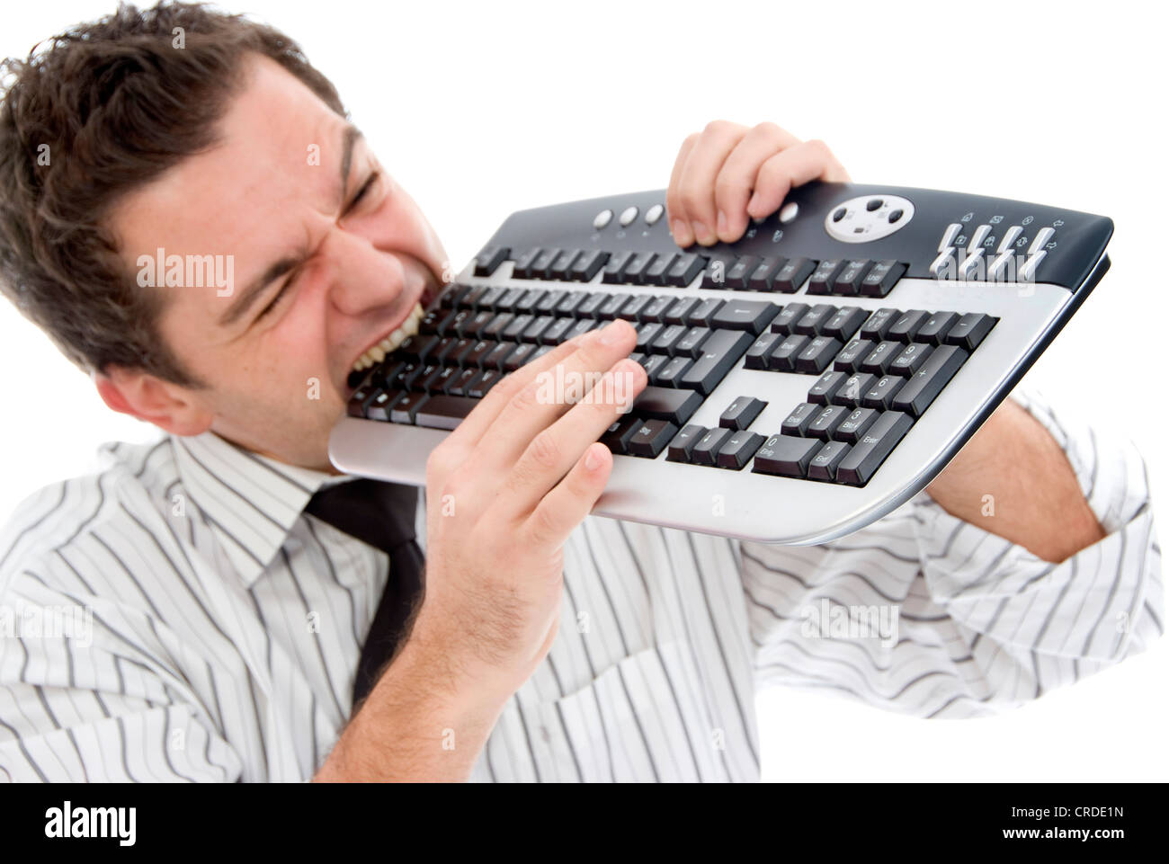 aggressive businessman biting in keyboard Stock Photo - Alamy