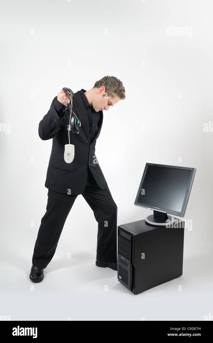 Young businessman hitting a computer Stock Photo - Alamy