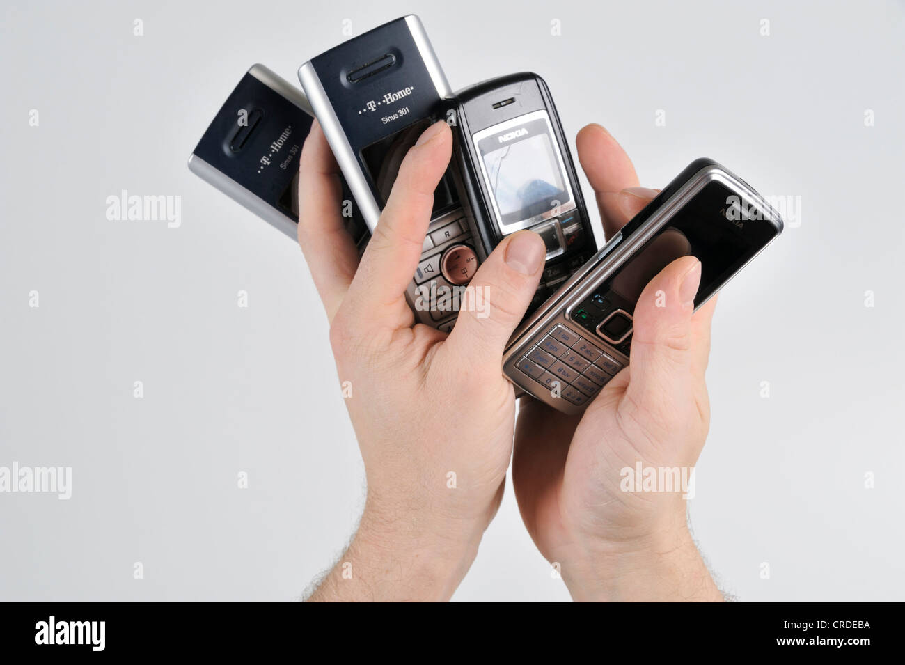 Hands holding mobile phones Stock Photo - Alamy