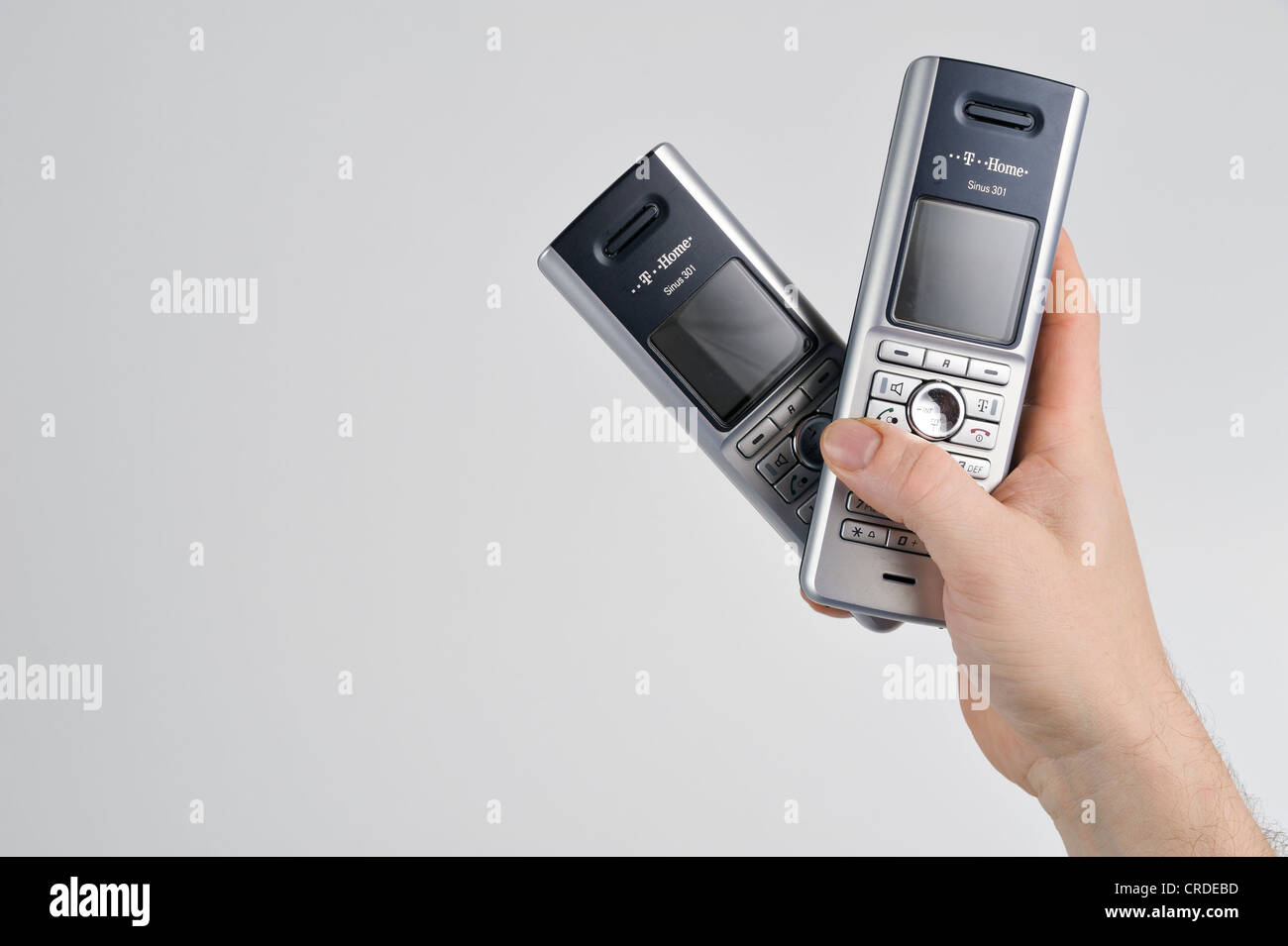 Hand holding mobile phones Stock Photo - Alamy