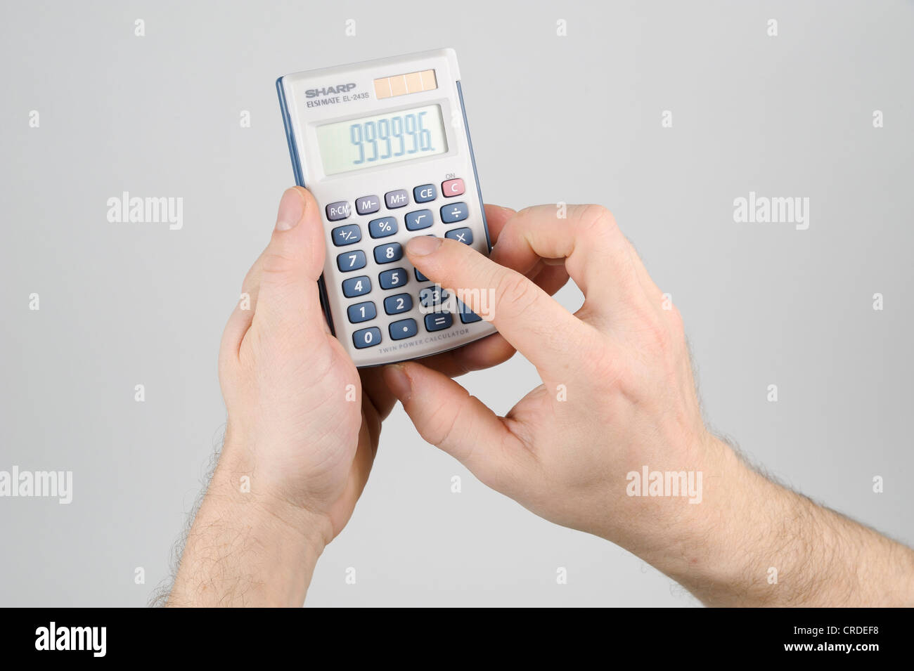 Hands holding a calculator Stock Photo - Alamy