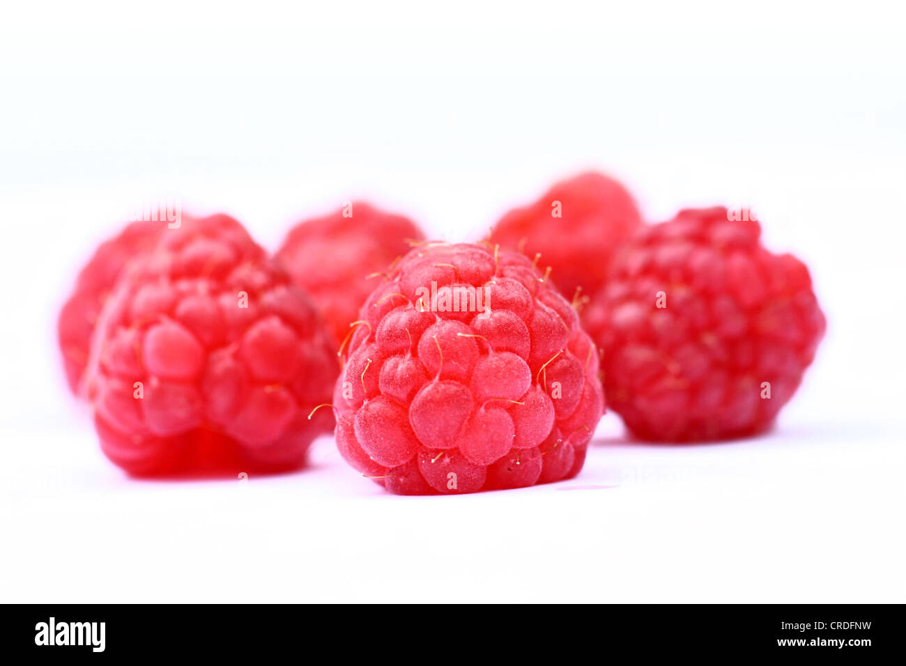 Ripe raspberries on white background Stock Photo - Alamy