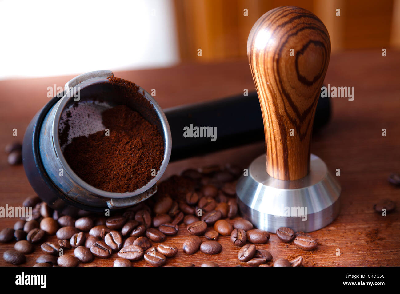 Espresso coffee beans, sieve and tamper Stock Photo - Alamy