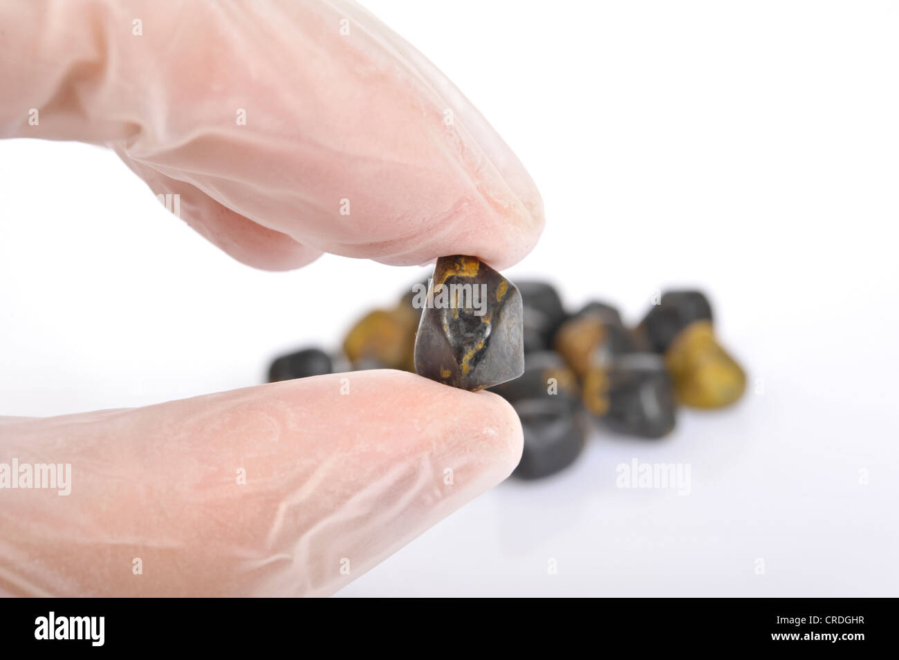 Fingers holding a gall stone, biliary calculus Stock Photo - Alamy