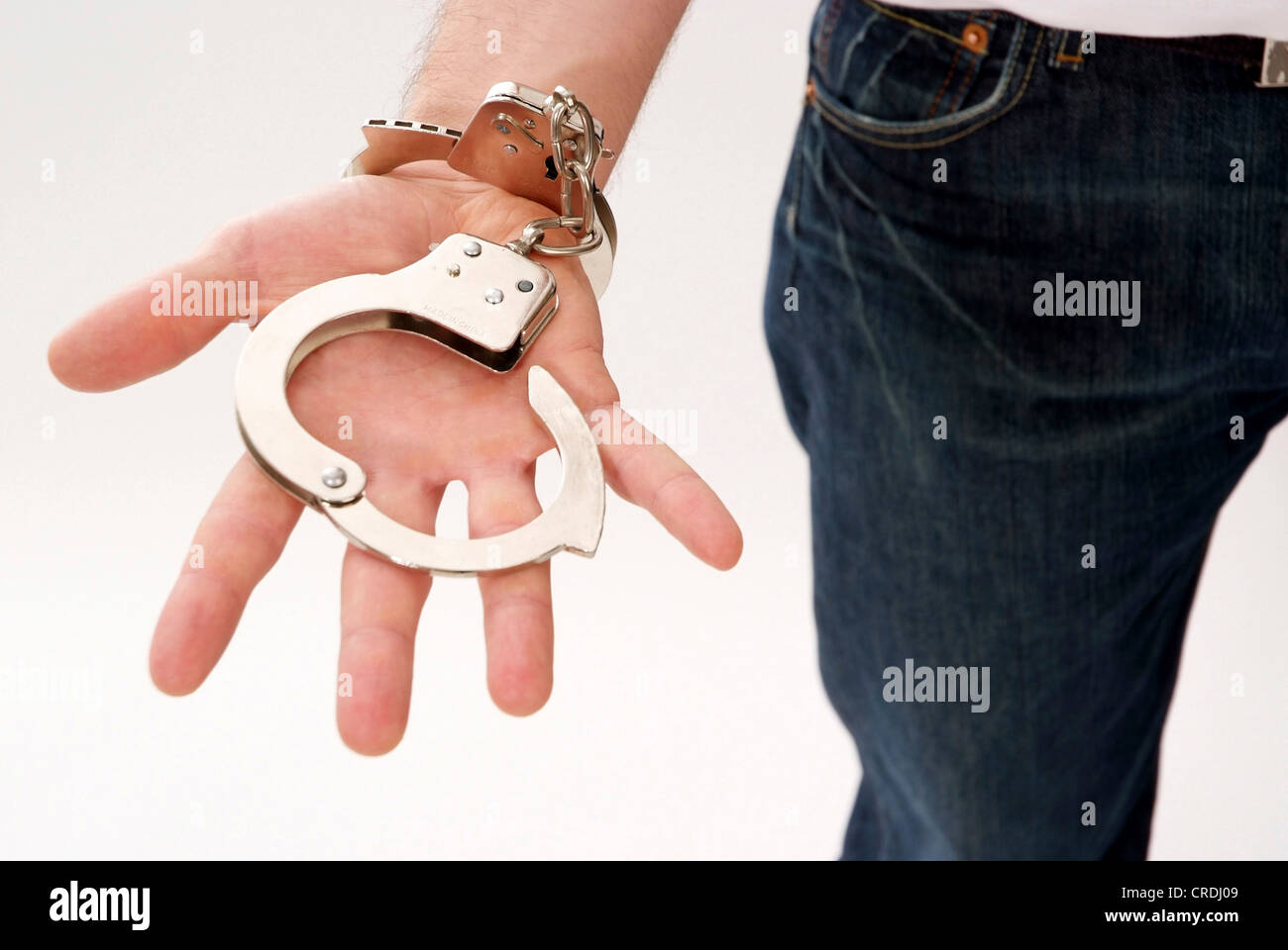man with opened handcuffs Stock Photo - Alamy